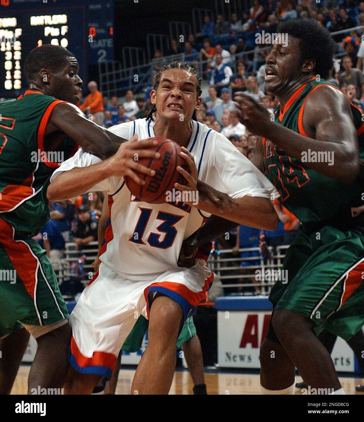 Florida's Joakim Noah (13) drives through Florida A&M's Michael, (25 ...