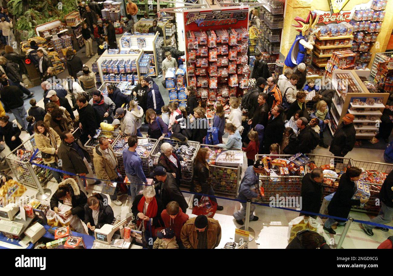People line up to buy items at a Toys R Us store in Times Square, New ...