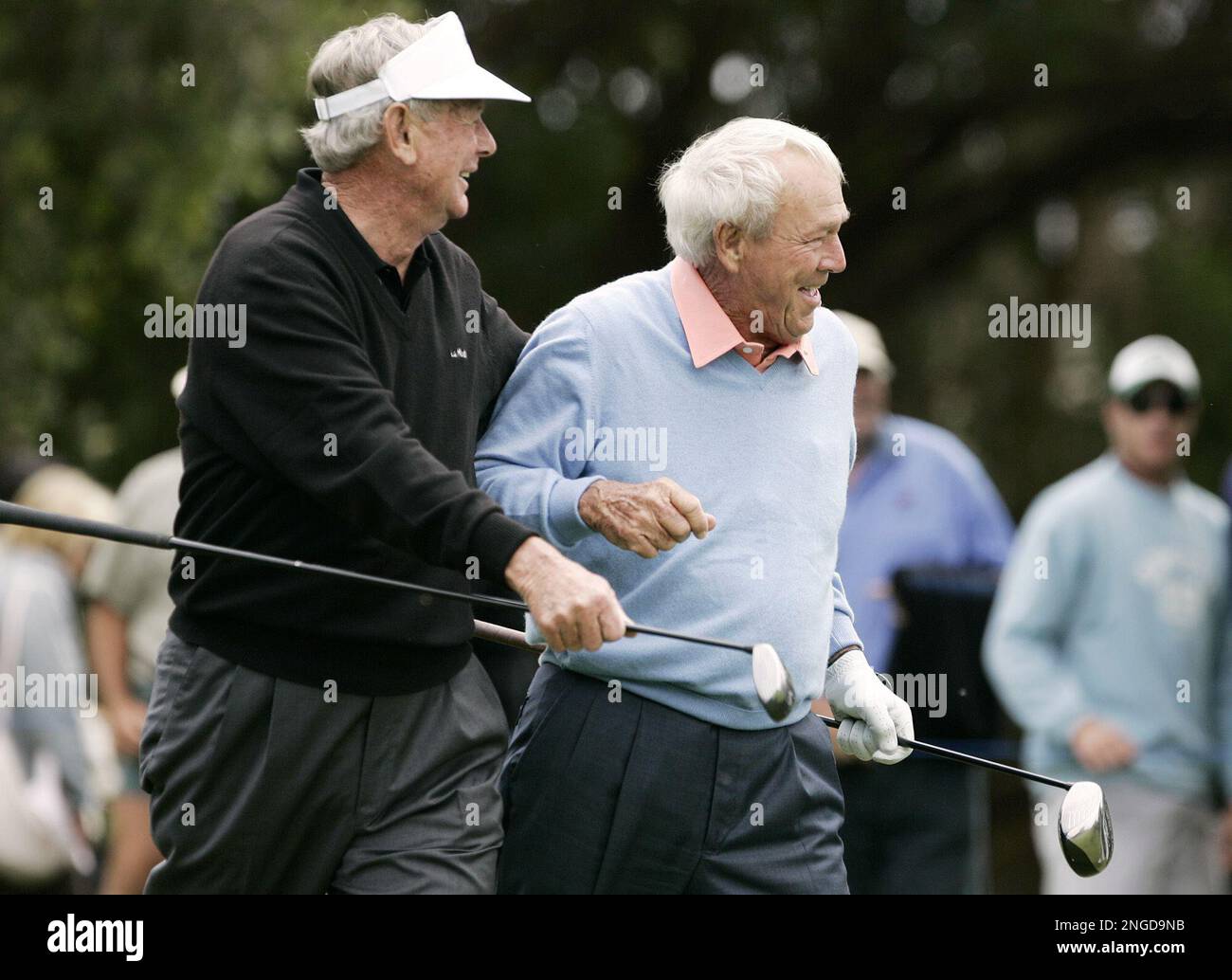 U.S. golfing legend Arnold Palmer, right, shares a joke with Australian ...