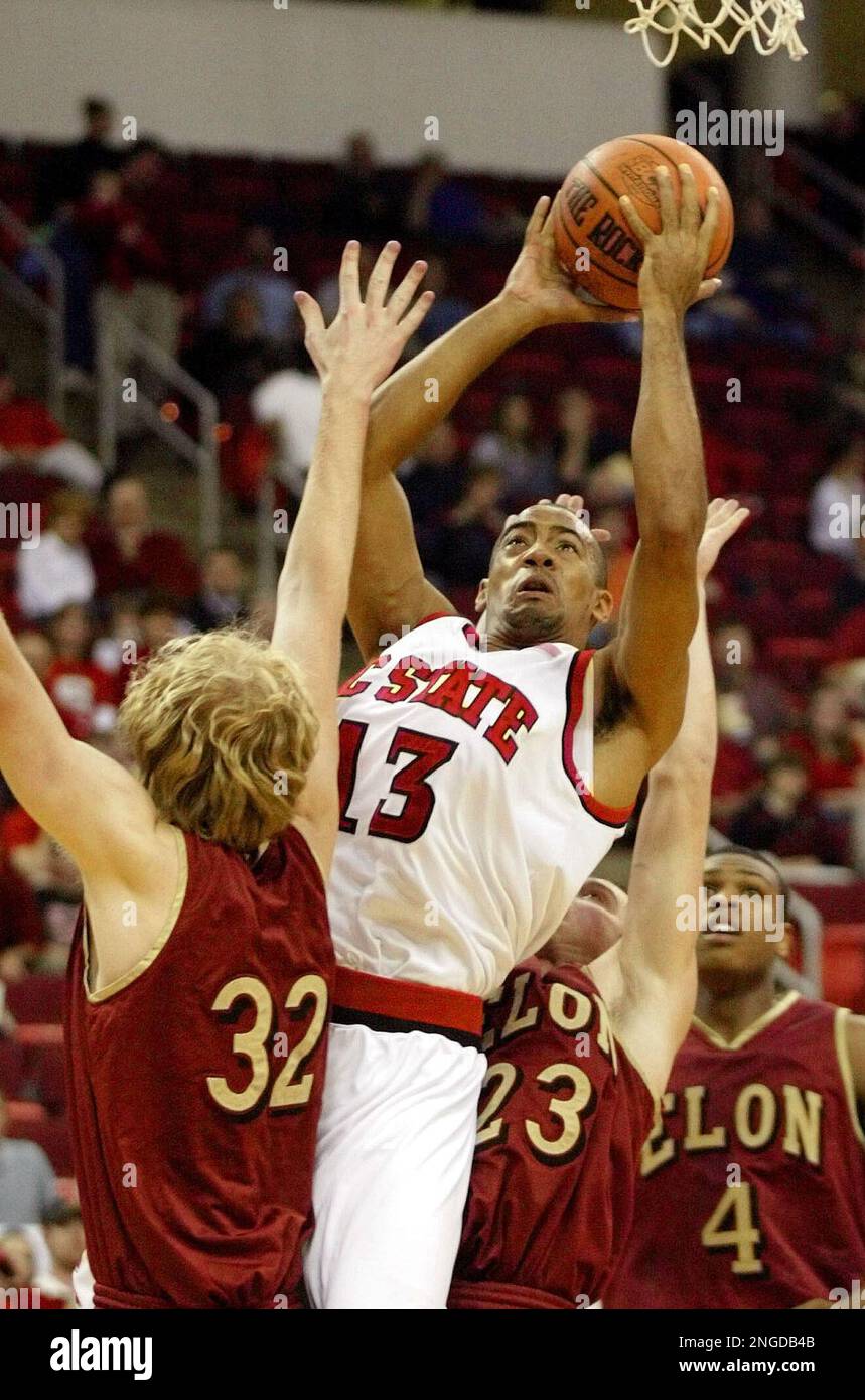 North Carolina State's Cameron Bennerman (13) drives between Elon's ...