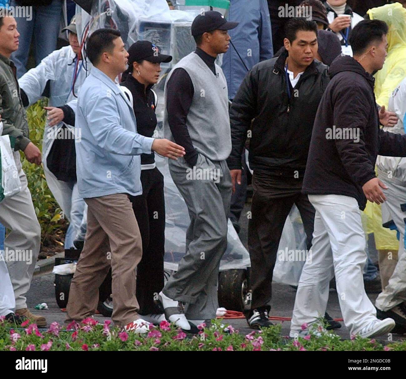Tiger Woods of the U.S. is surrounded by bodyguards as Woods moves to ...