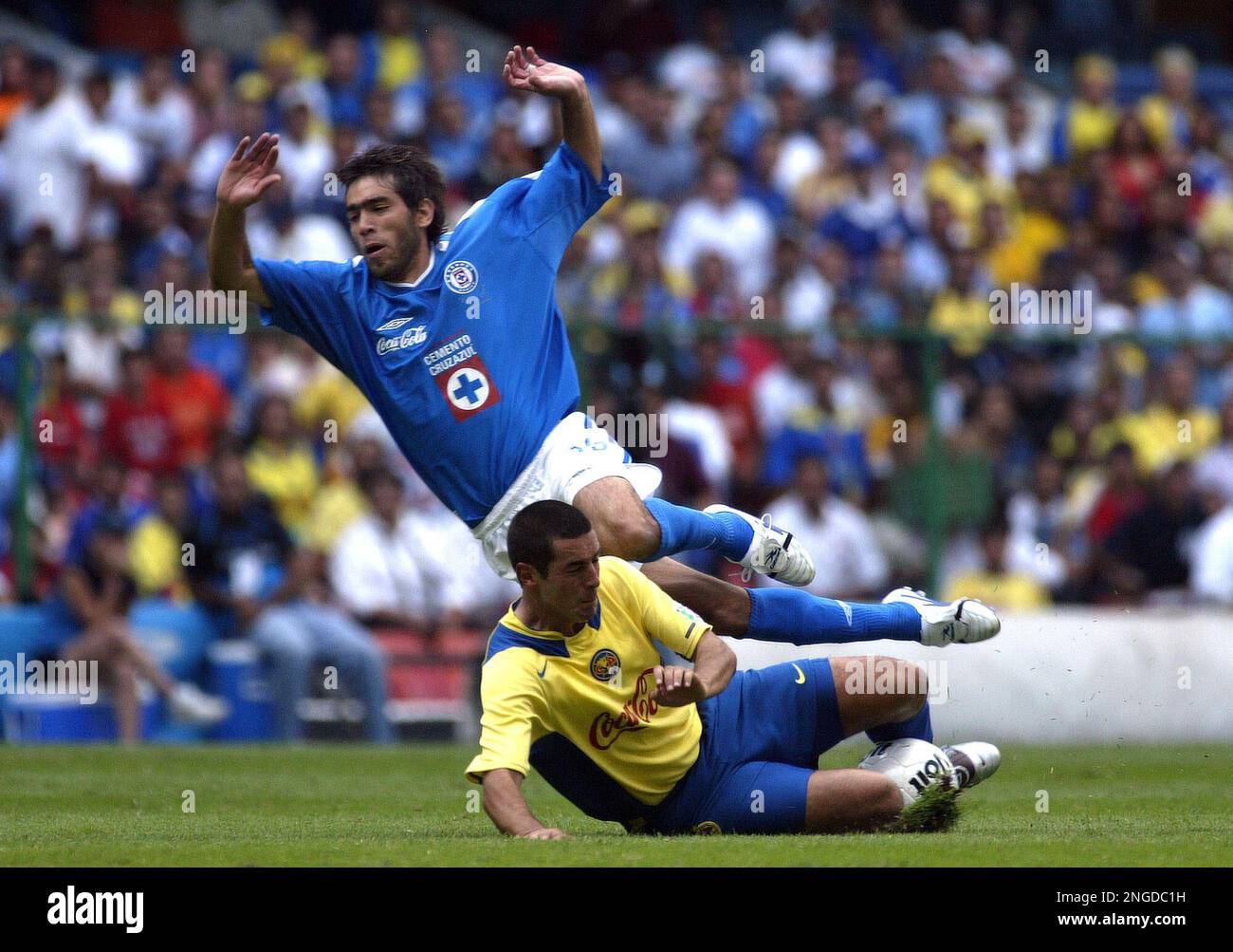 Cruz Azul's Cesar Delgado, top, from Argentina is fouled by America's ...