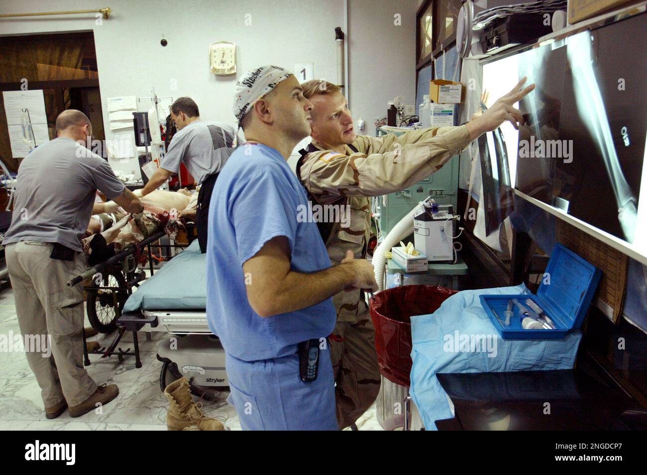 U.S. Army surgeons discuss patient x-rays in the emergency room of the ...