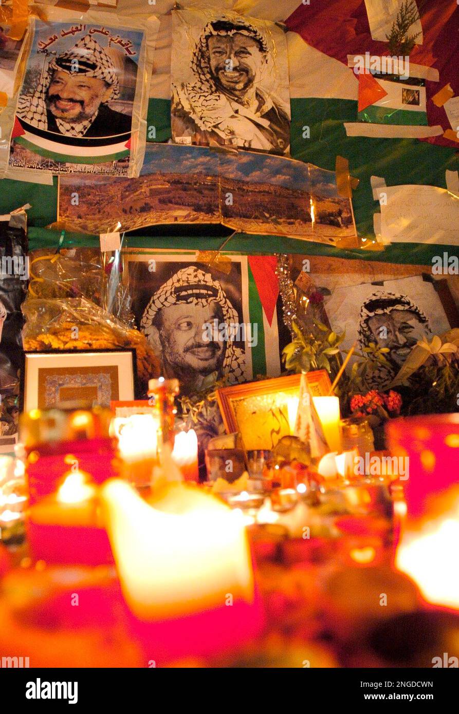 Candles lit up portraits of ailing Palestinian leader Yasser Arafat at ...