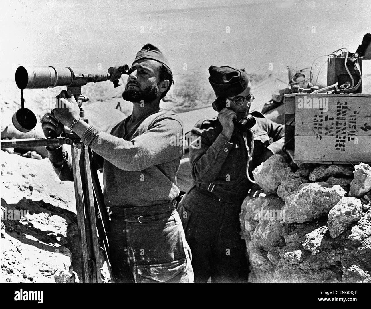 A Free French soldier observes German tanks at a forward outpost in ...