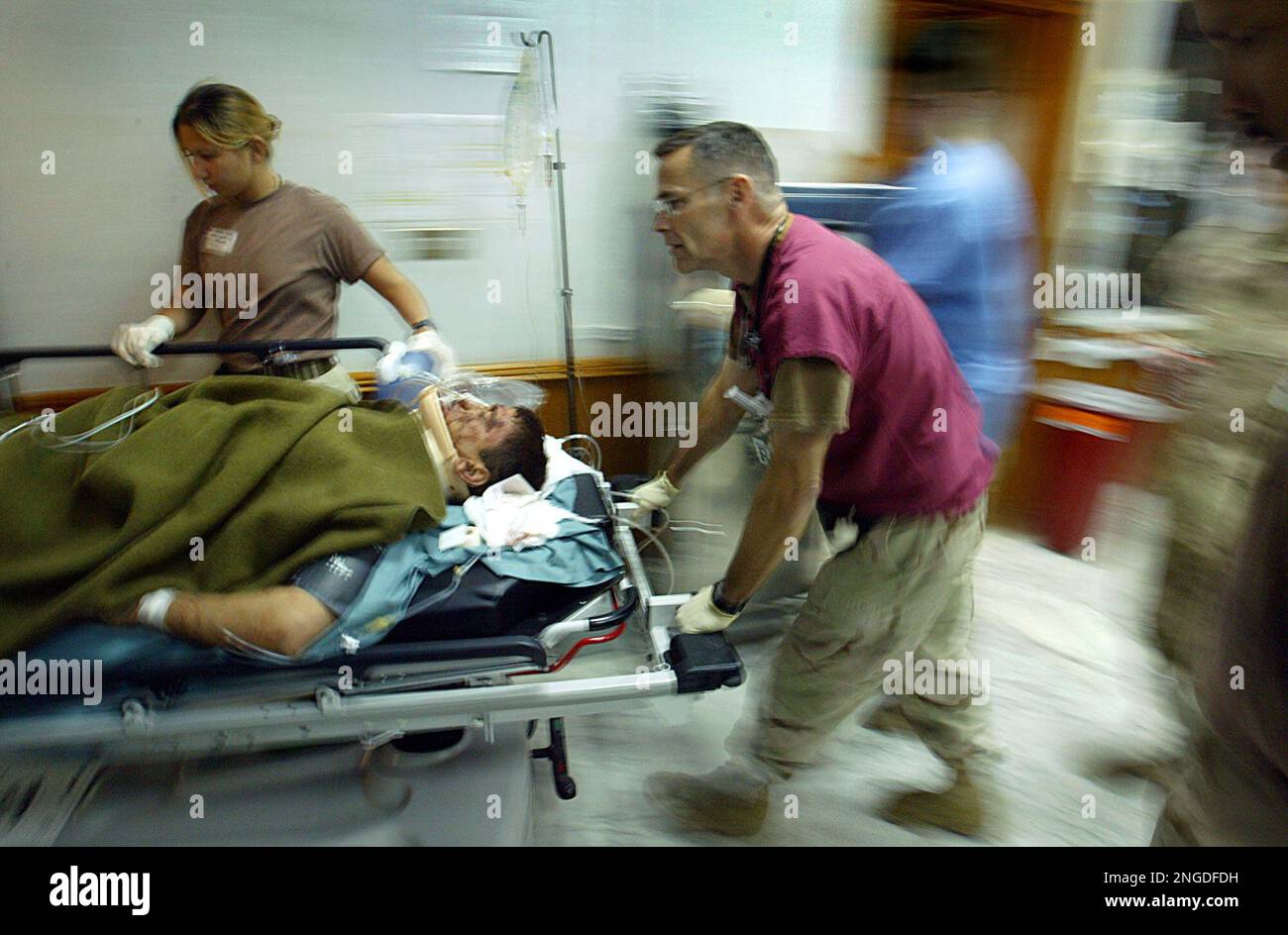U.S. Army head nurse LTC Greg Kidwell pushes a seriously wounded Iraqi ...