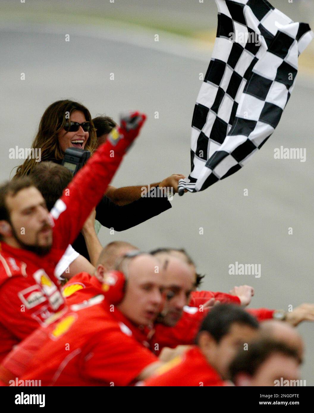Brazilian super model Gisele Bundchen waves the checker flag at the F1 ...