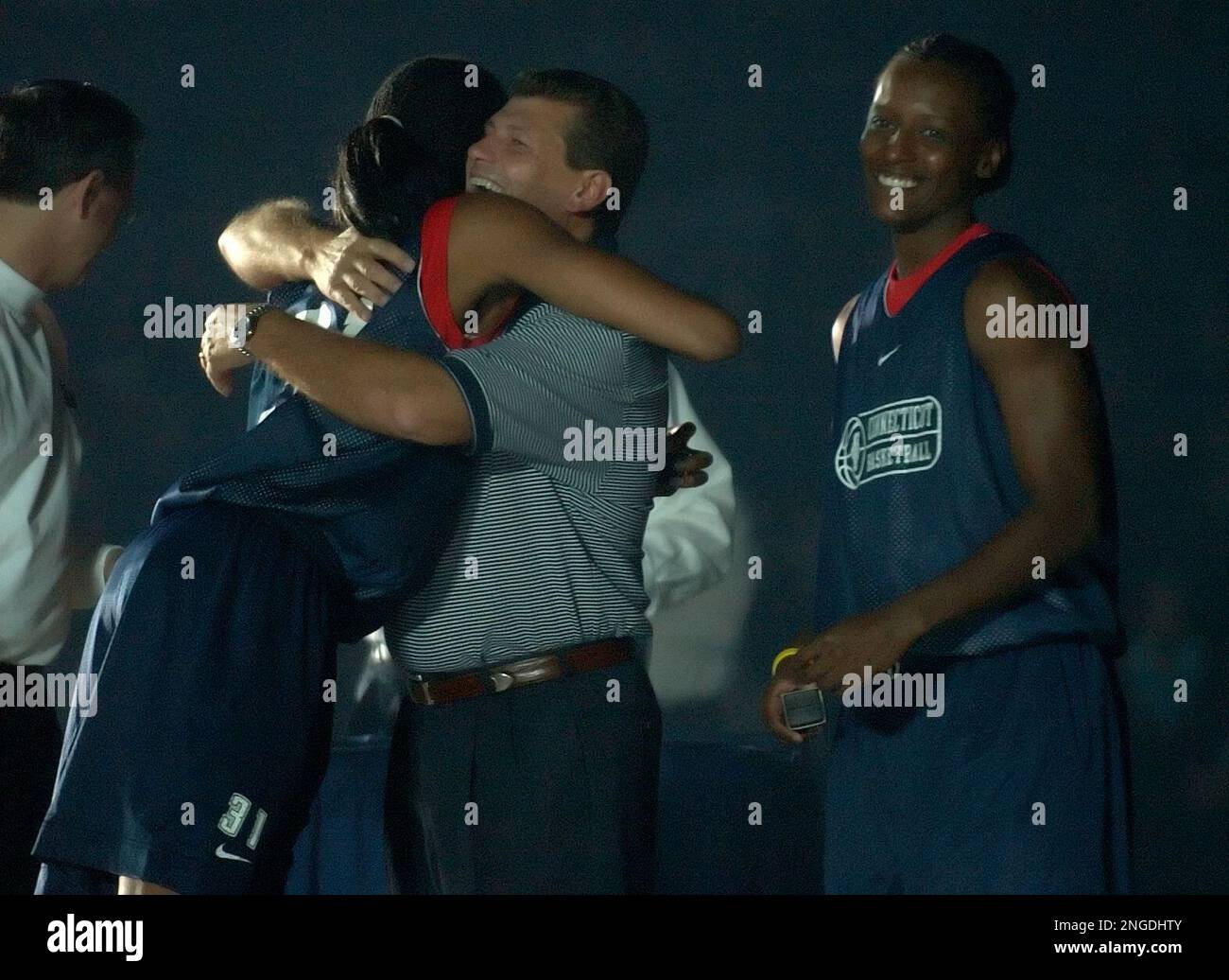 Connecticut's Jessica Moore, left gives coach Geno Auriemma a hug as ...