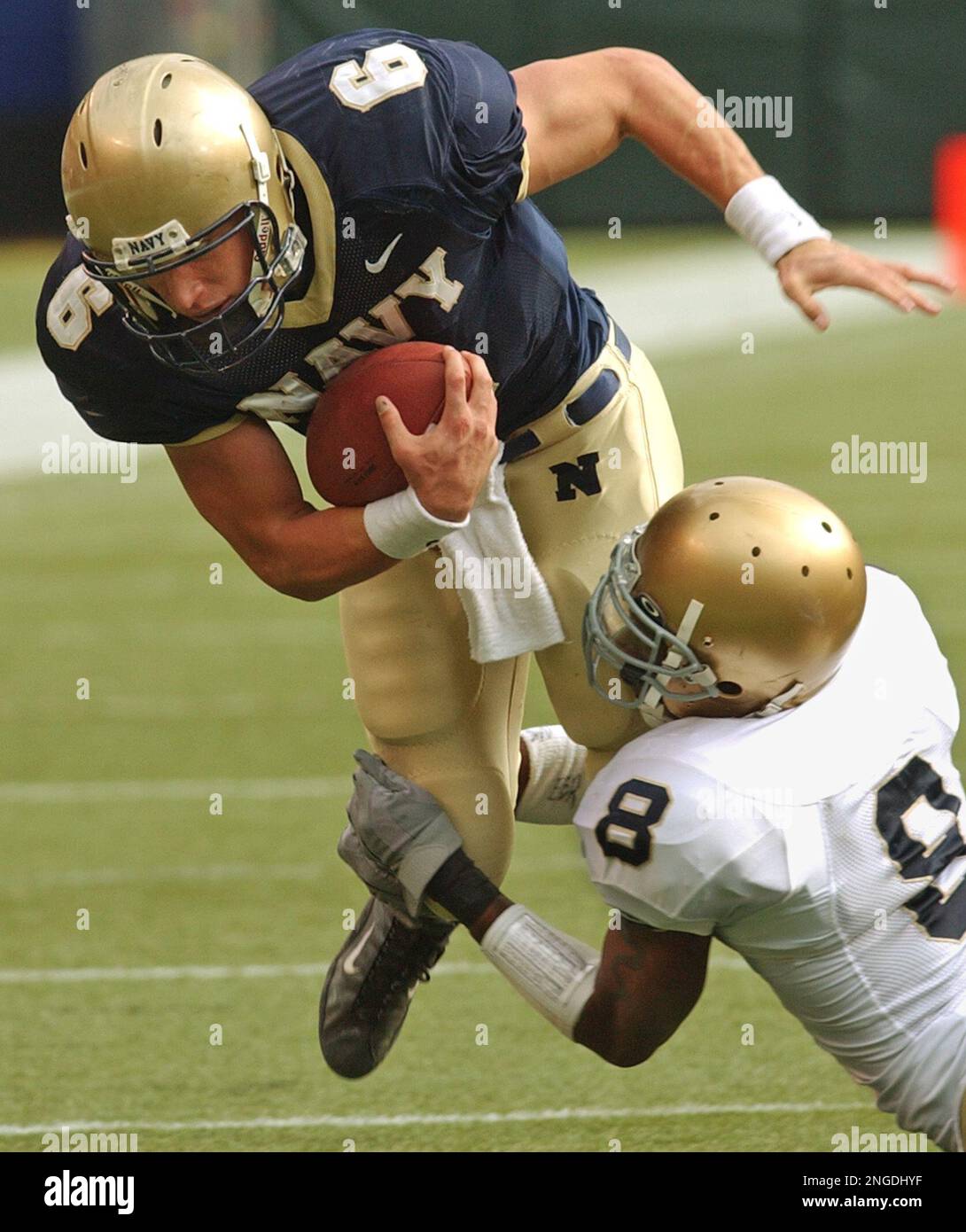 Navy quarterback Aaron Polanco, left, is tackled by Notre Dame safety ...