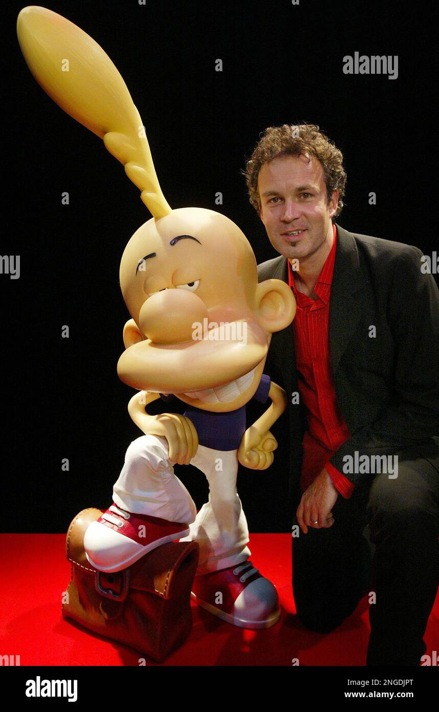 Swiss cartoonist Philippe Chapuis, known as Zep, poses with the statue ...