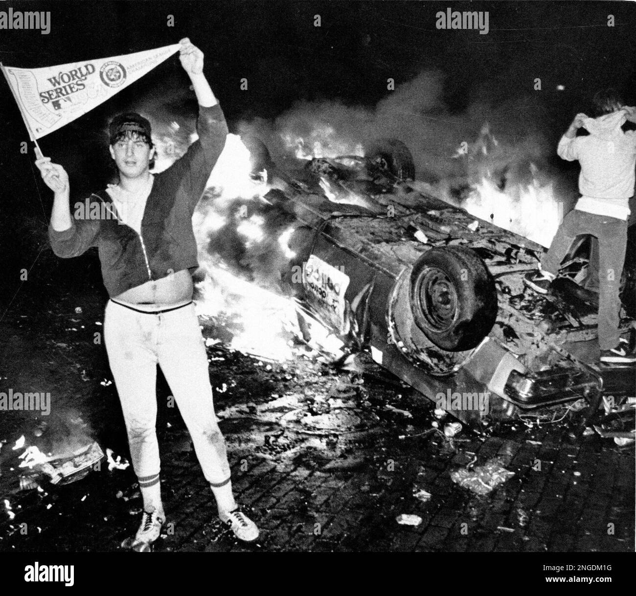 Kenneth "Bubba" Helms stands next to a burning Detroit police car after ...