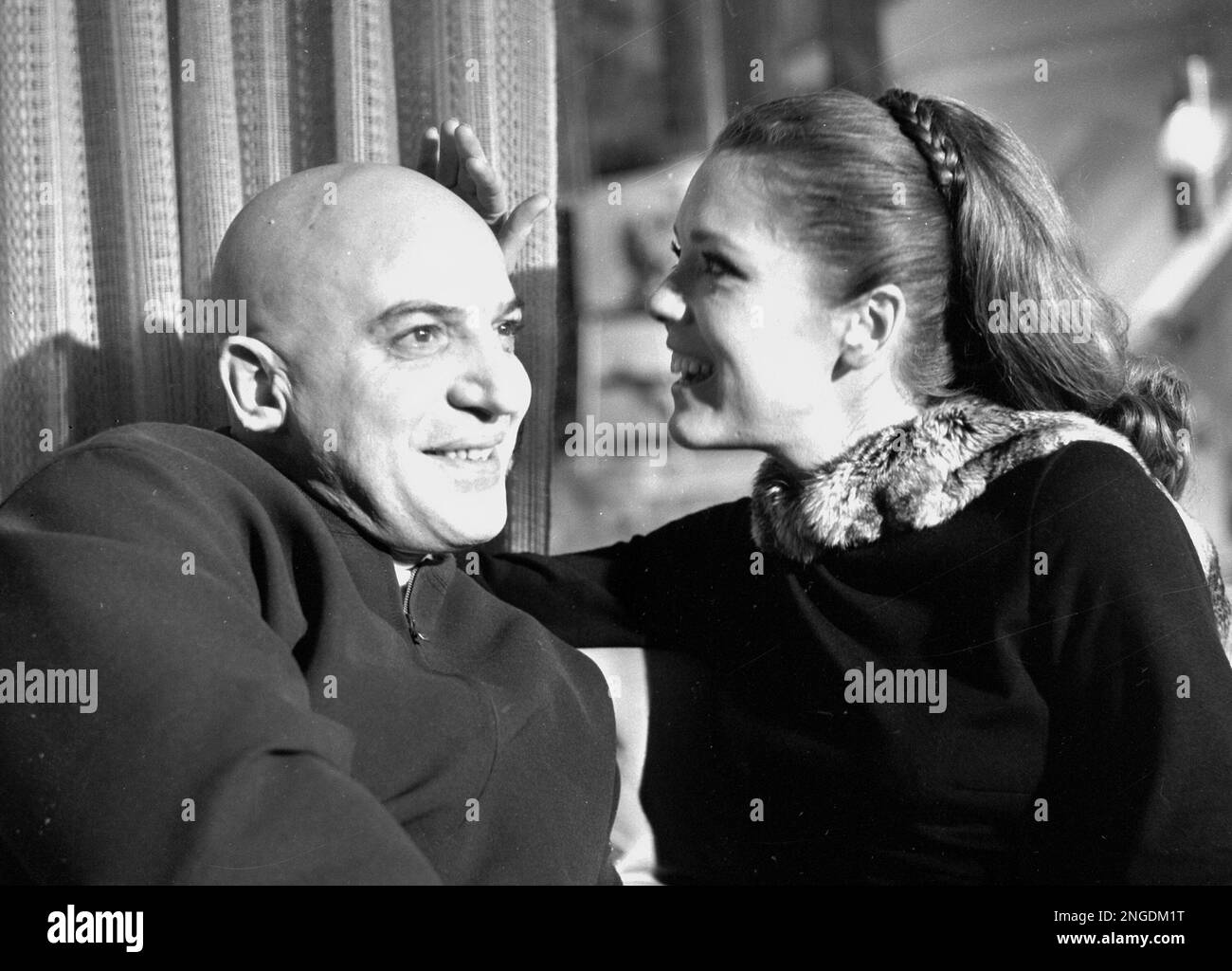 British actress Diana Rigg strokes the head of U.S. actor Telly Savalas ...