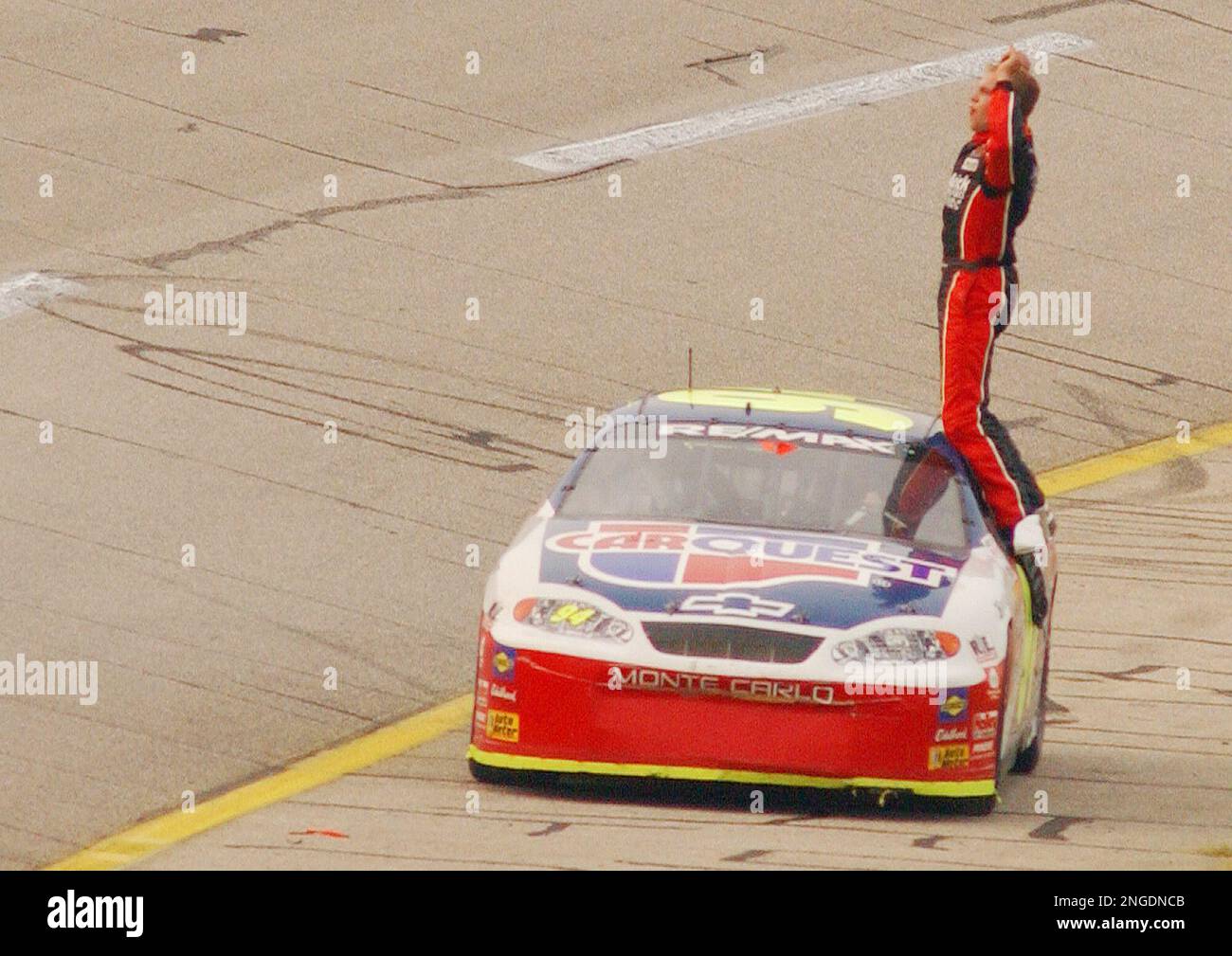 Blake Feese stands on his car in the tri-oval of the Talladega ...