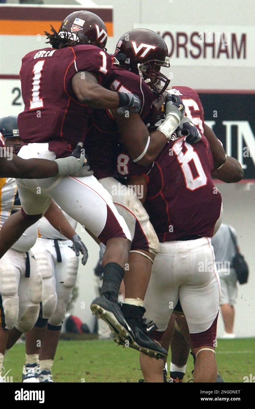 Virginia Tech safety Vincent Fuller (8) is swarmed by teammates after ...