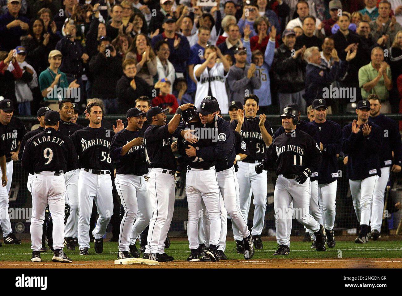 Seattle Mariners' Ichiro Suzuki, center, is congratulated by manager ...