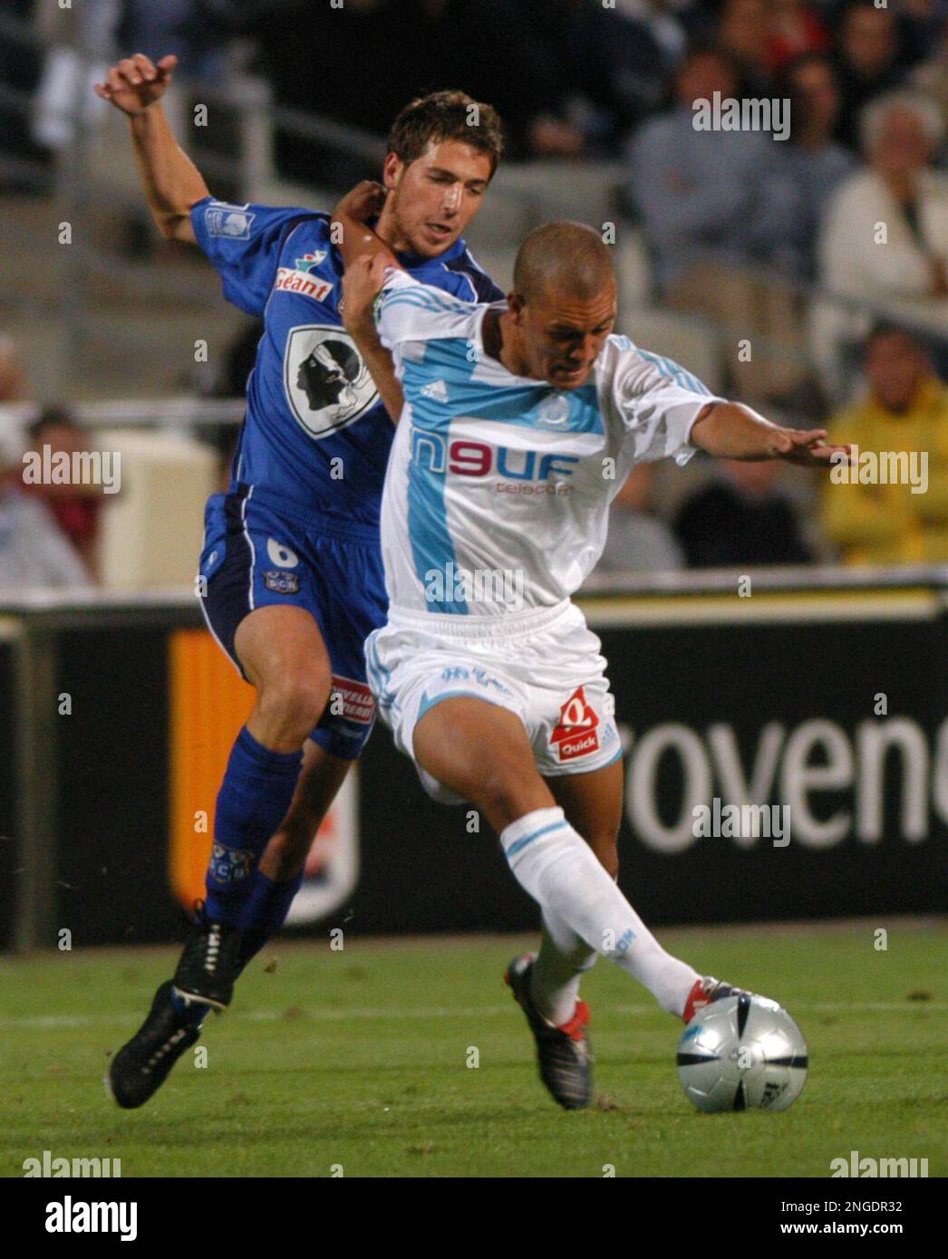 Brazilian player of Marseille Eduardo Costa, right, fights for the ball ...