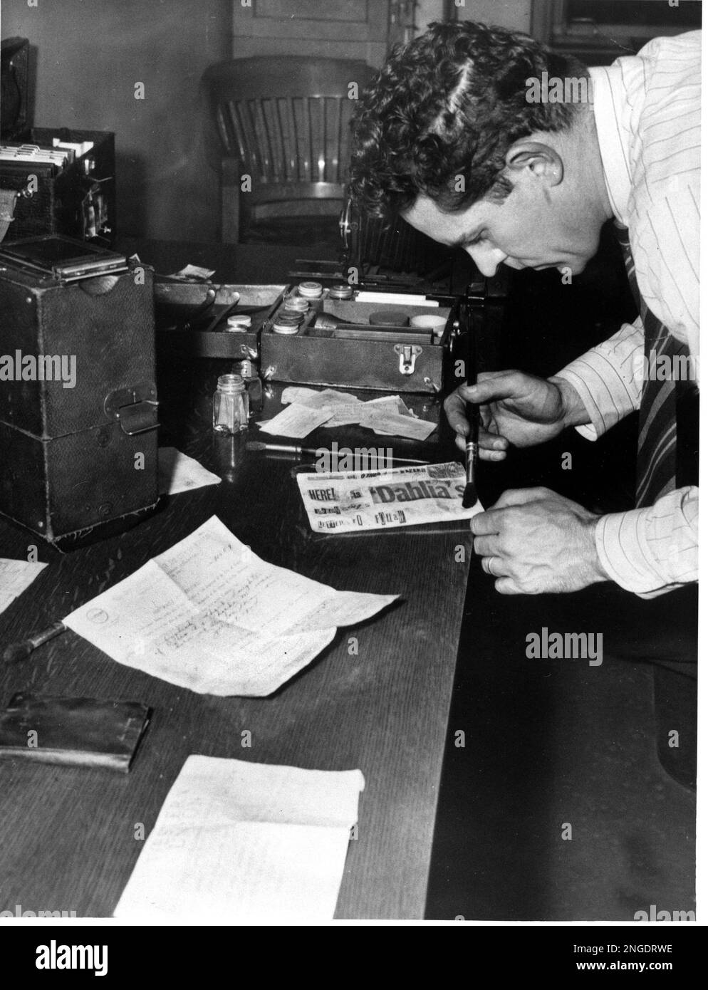 George Wheeler of the Los Angeles Police fingerprint division checks ...