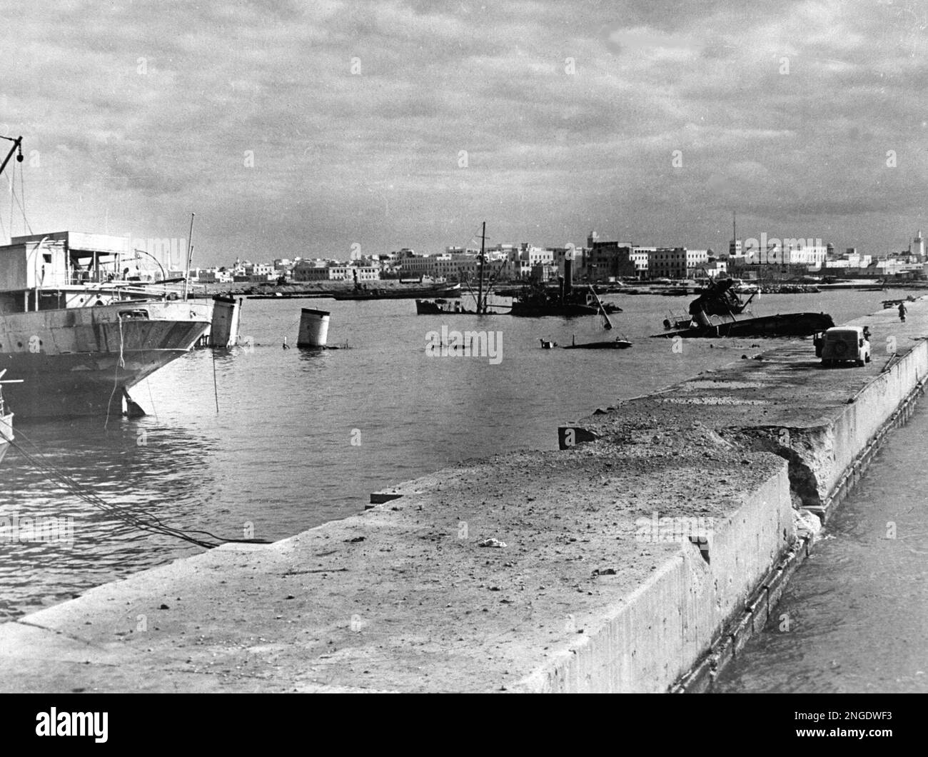 Several sunken Axis ships are visible in the harbour at Benghazi, in ...