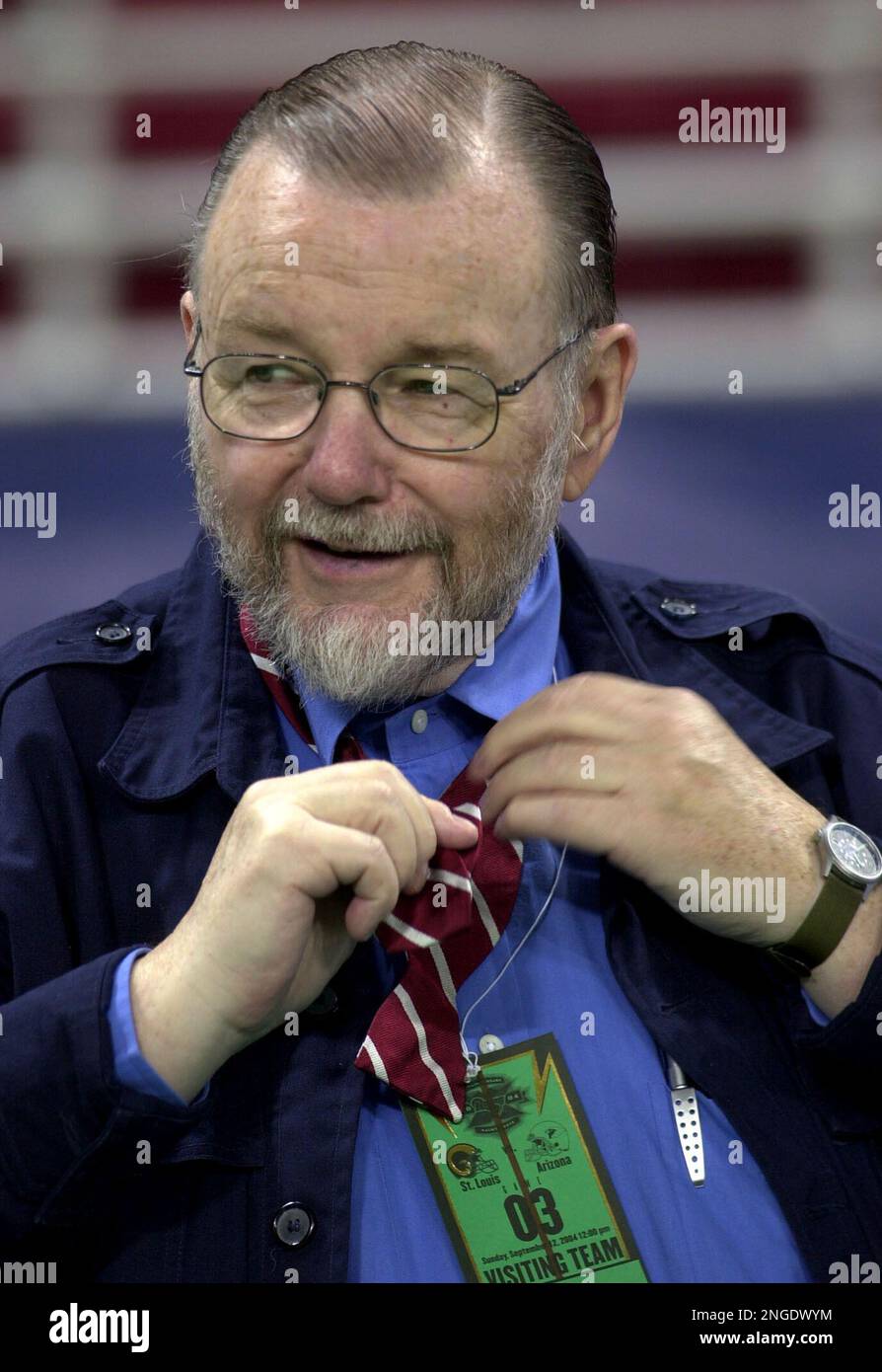 Bill Bidwell, owner of the Phoenix Cardinals put on his bowtie while ...