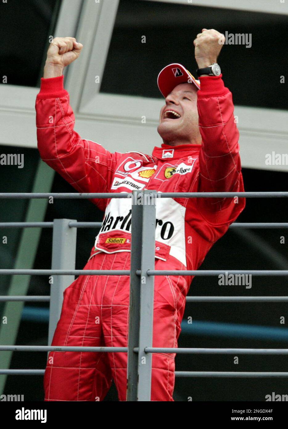 F1 Ferrari driver Rubens Barrichello of Brazil celebrates on the podium ...