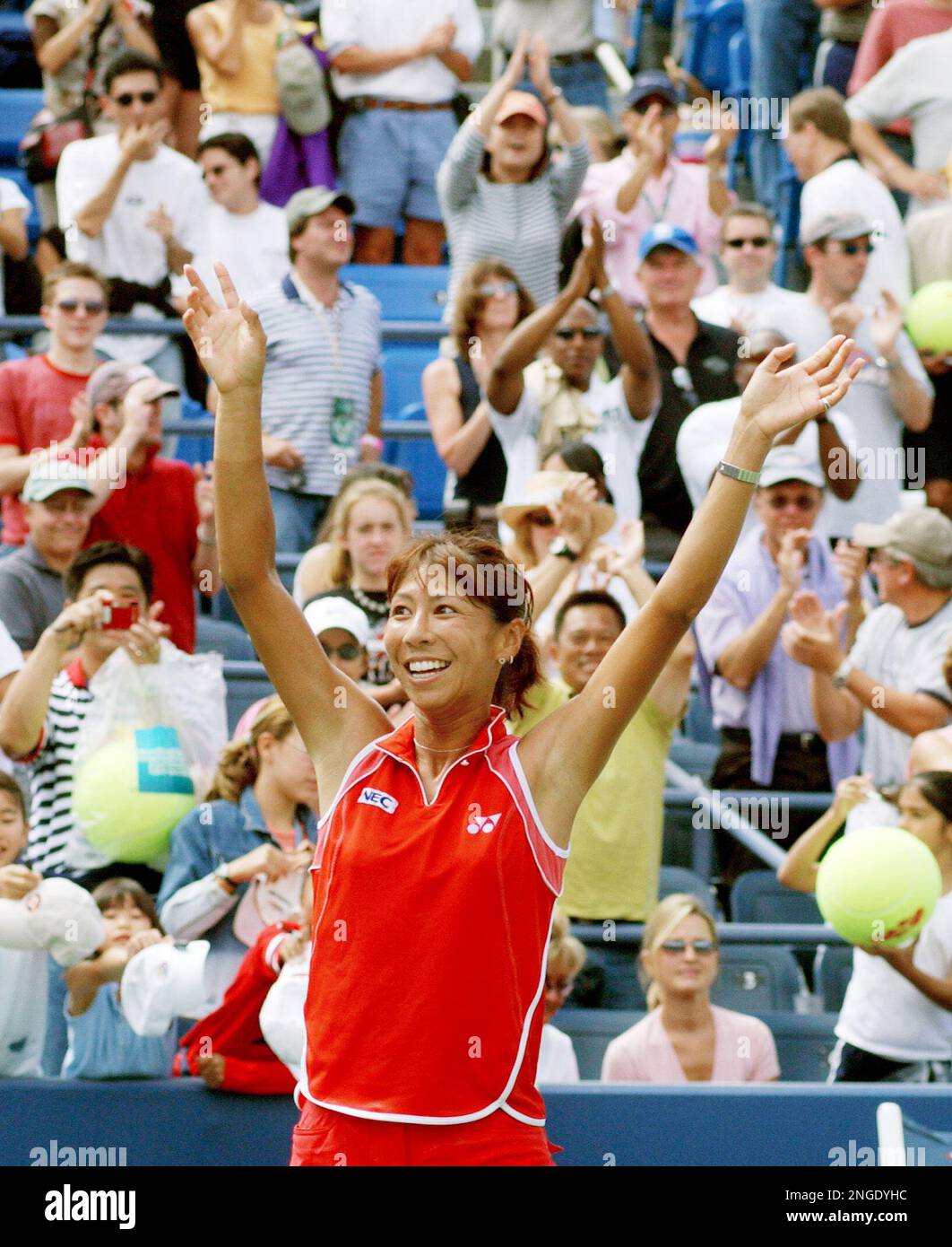 The crowd joins Shinobu Asagoe, of Japan, as she celebrates her victory ...