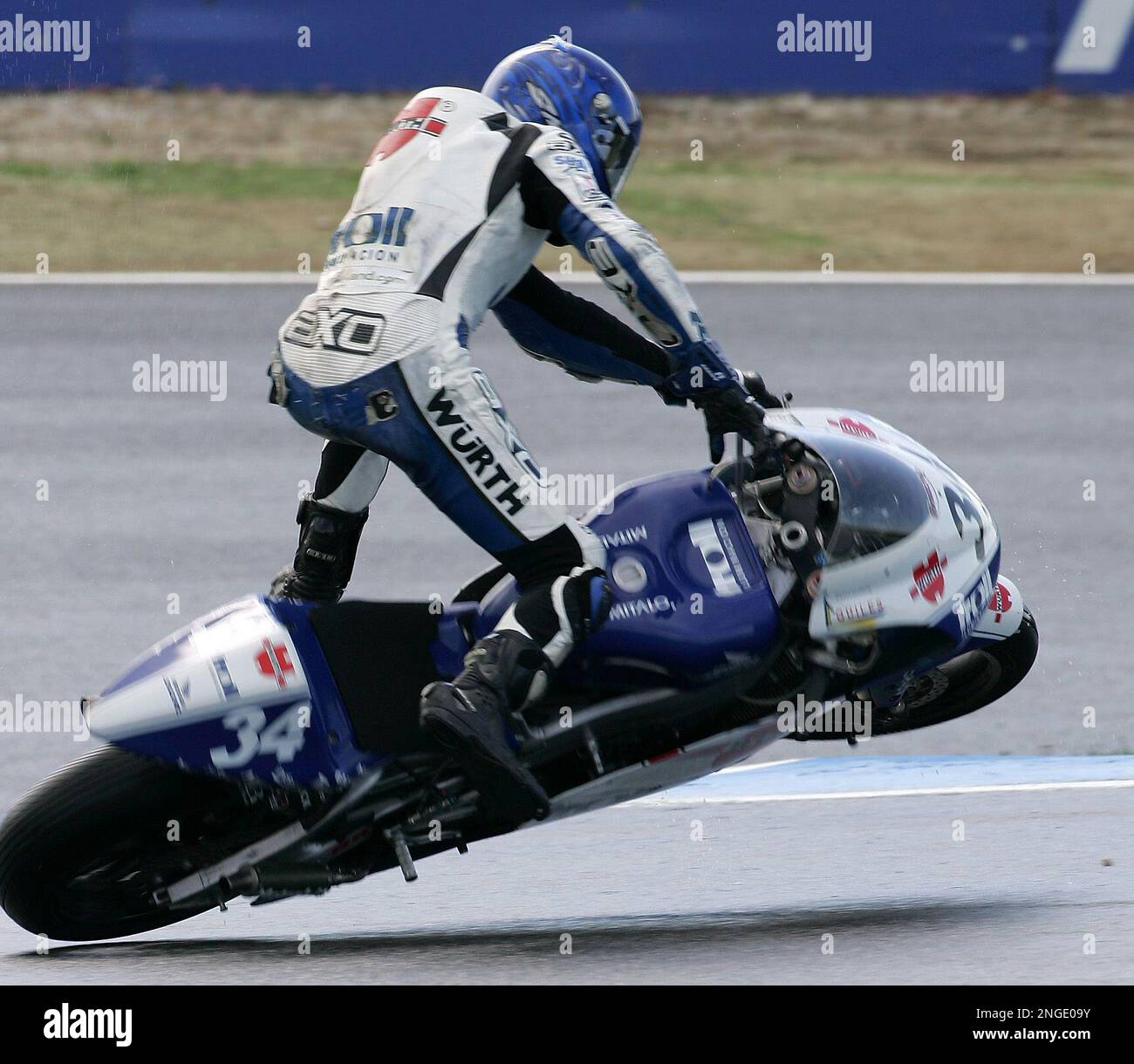France's Eric Bataille falls off his 250cc Aprilia during the free ...
