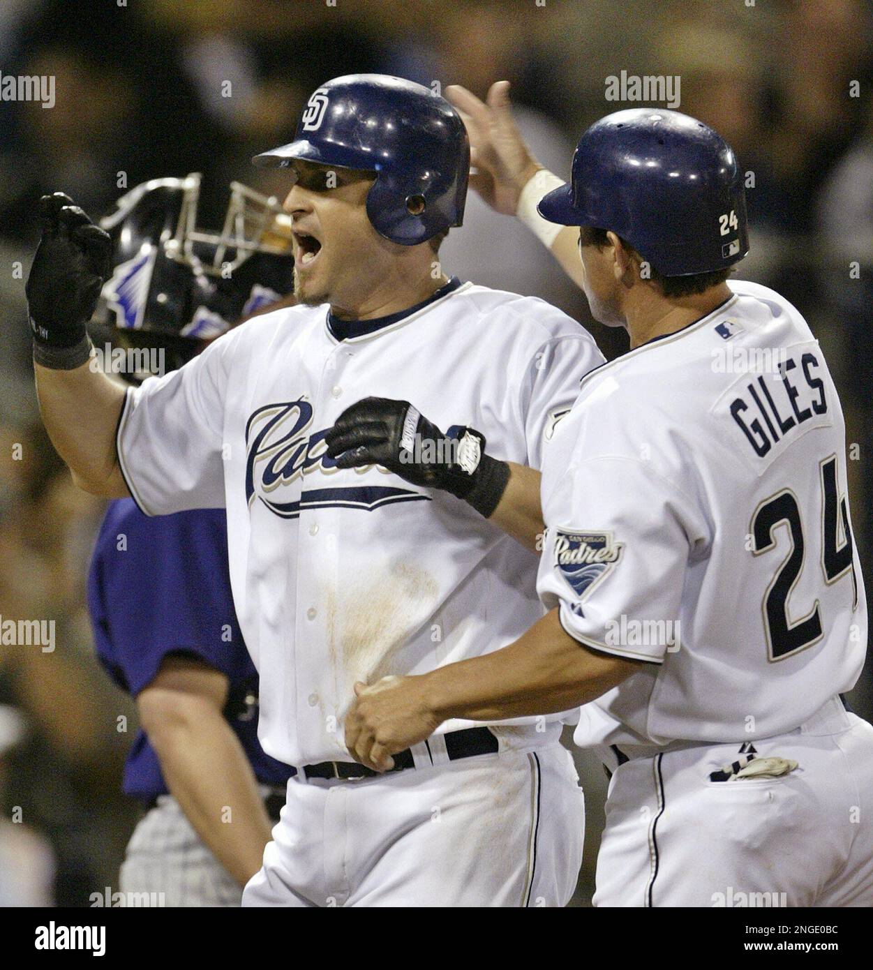 San Diego Padres' Phil Nevin, left, is greeted by Brian Giles after his ...