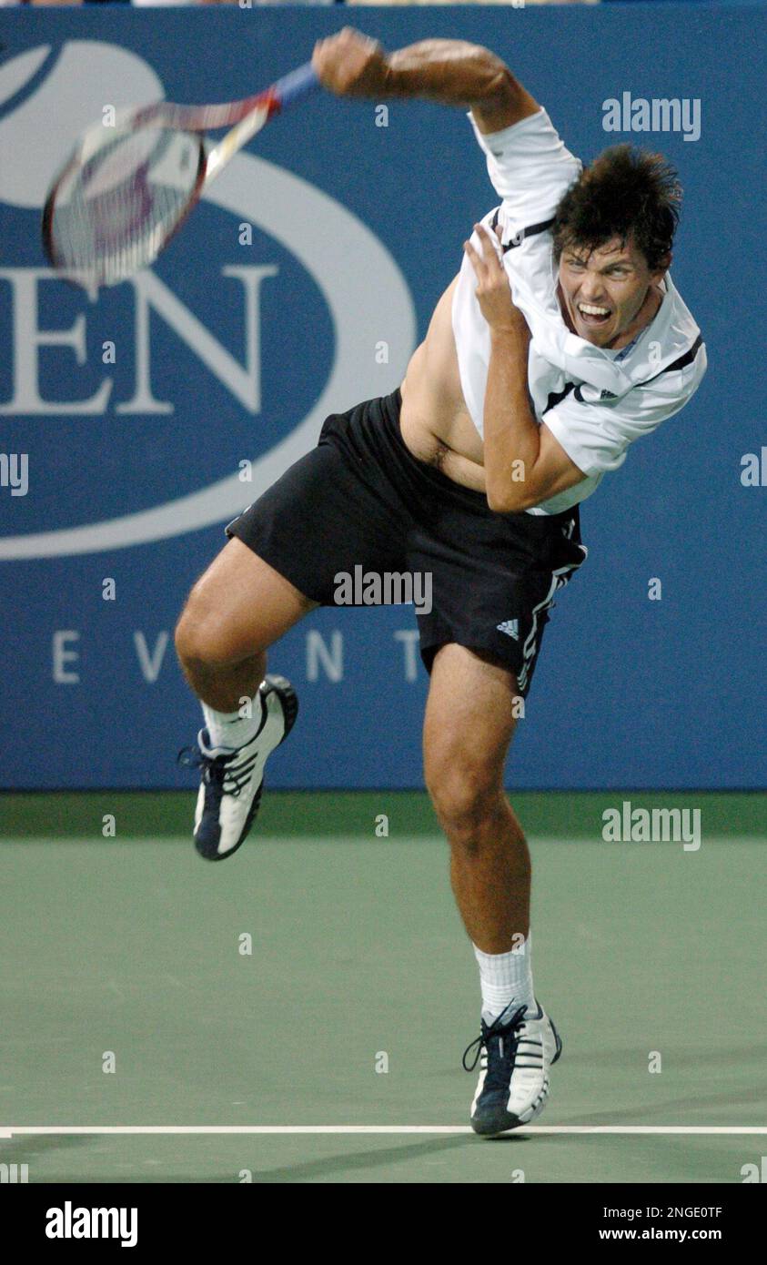 Taylor Dent, of the United States, returns a shot to Paul-Henri Mathieu ...