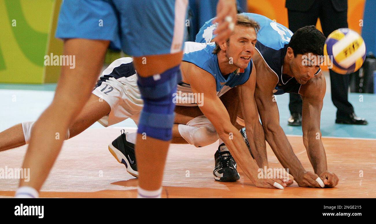 Italy's Damiano Pippi, left, and Andrea Giani, right, go after a ball ...