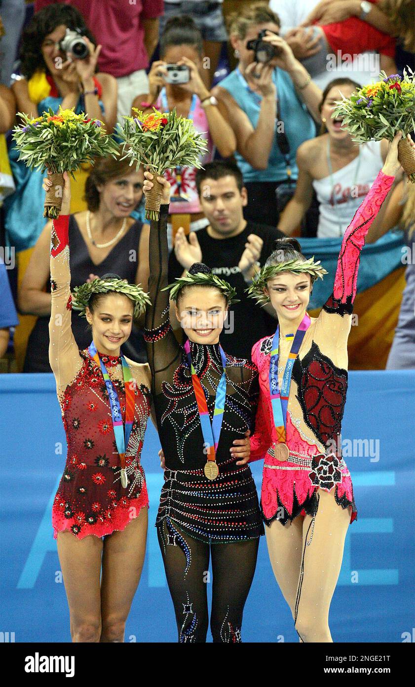 Alina Kabaeva of Russia, center, who won the gold medal, waves with ...