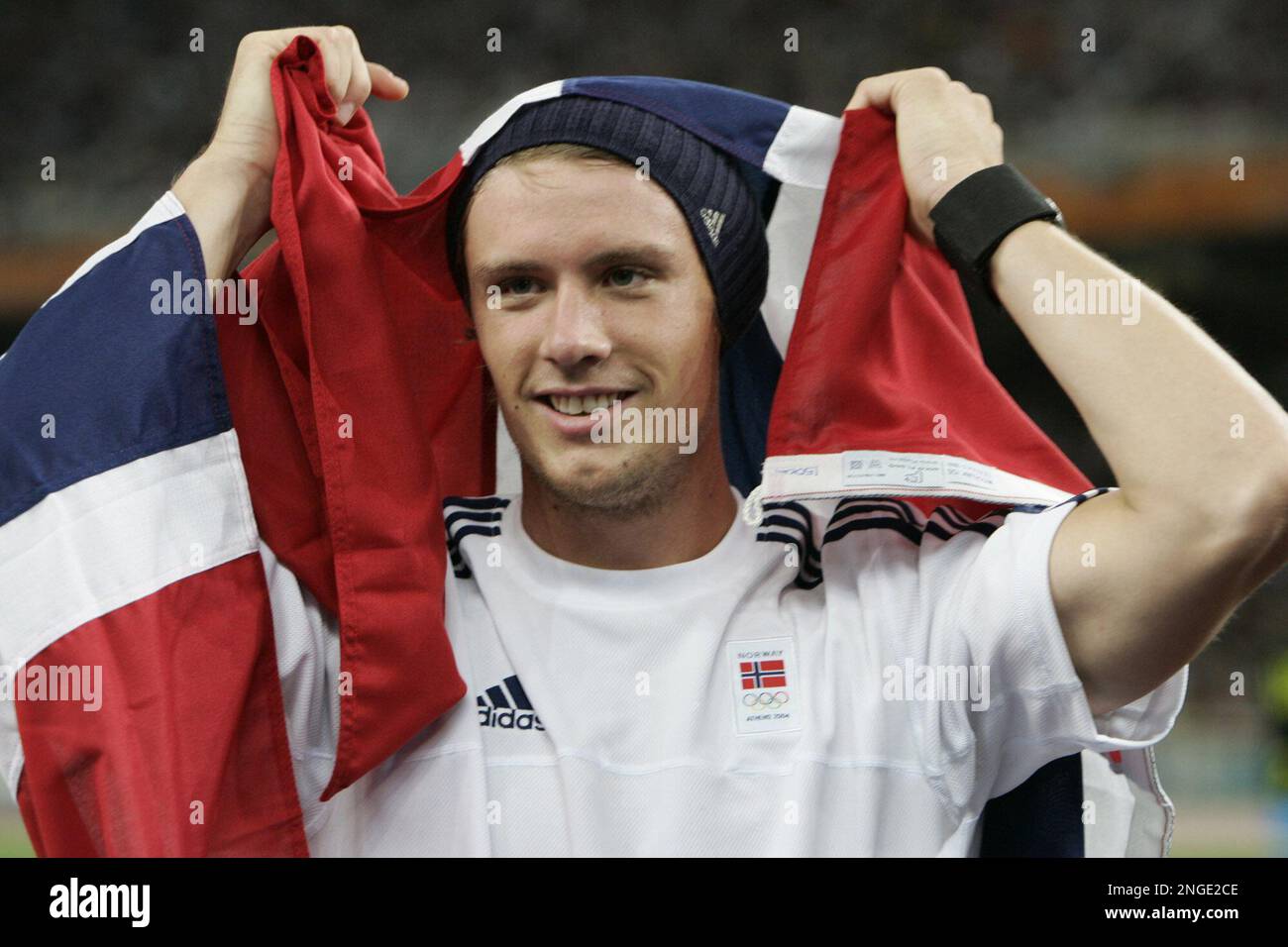 Norway's Andreas Thorkildsen wraps himself in his national flag, after winning the gold medal in ...