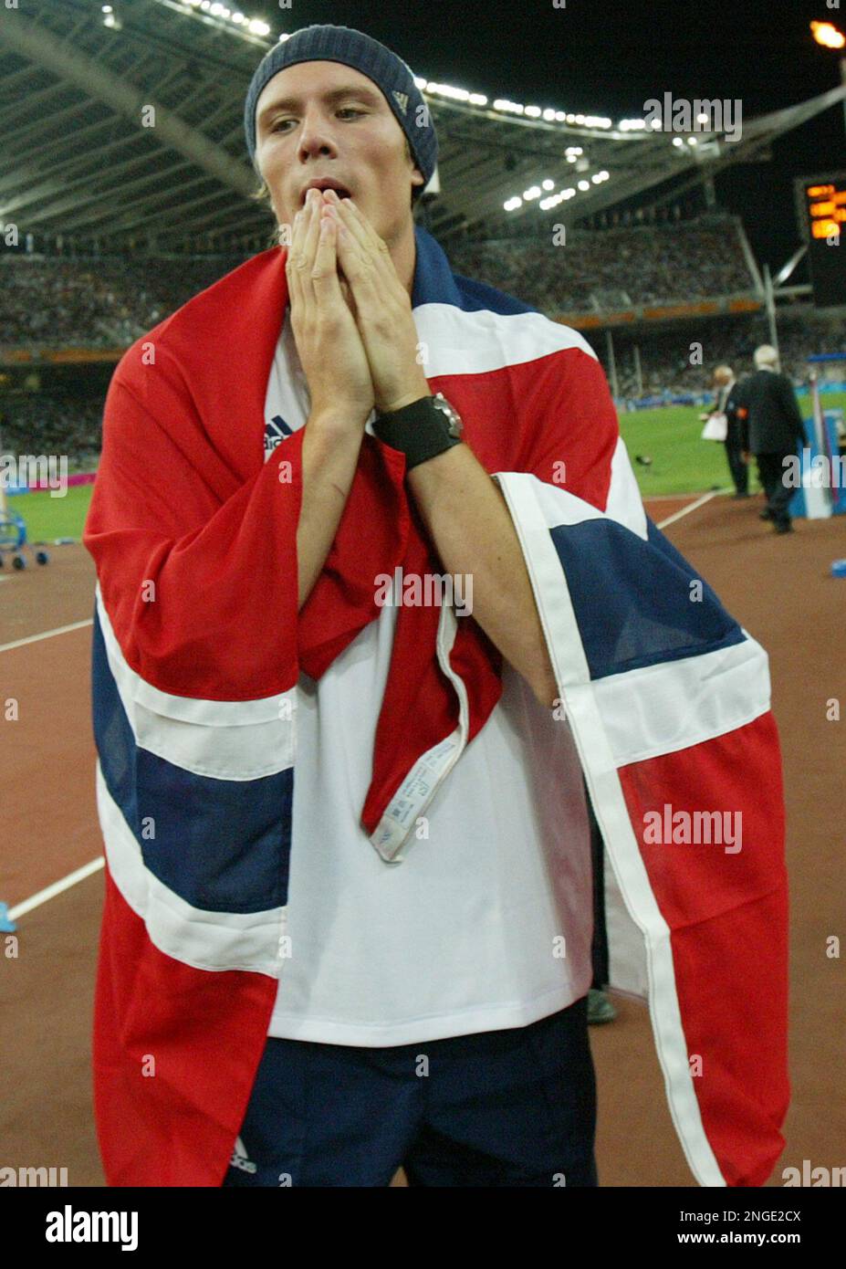 Norway's Andreas Thorkildsen wraps himself in his national flag, after winning the gold medal in ...