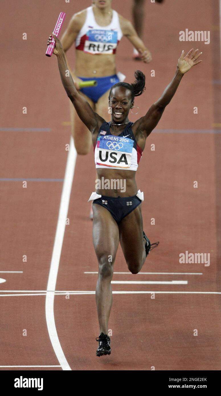 The United States' Sanya Richards reacts as she crosses the finish line ...