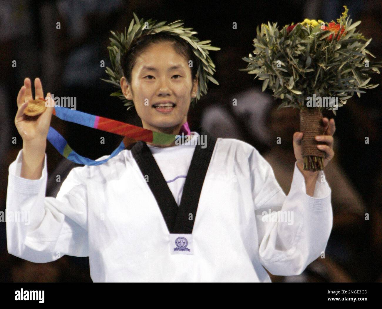 Ji Won Jang, from Korea, displays her gold medal in women's under 57kg at taekwondo, Friday, Aug ...