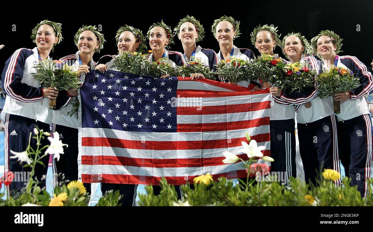 Members of USA's bronze medal winning team pose for pictures holding a ...