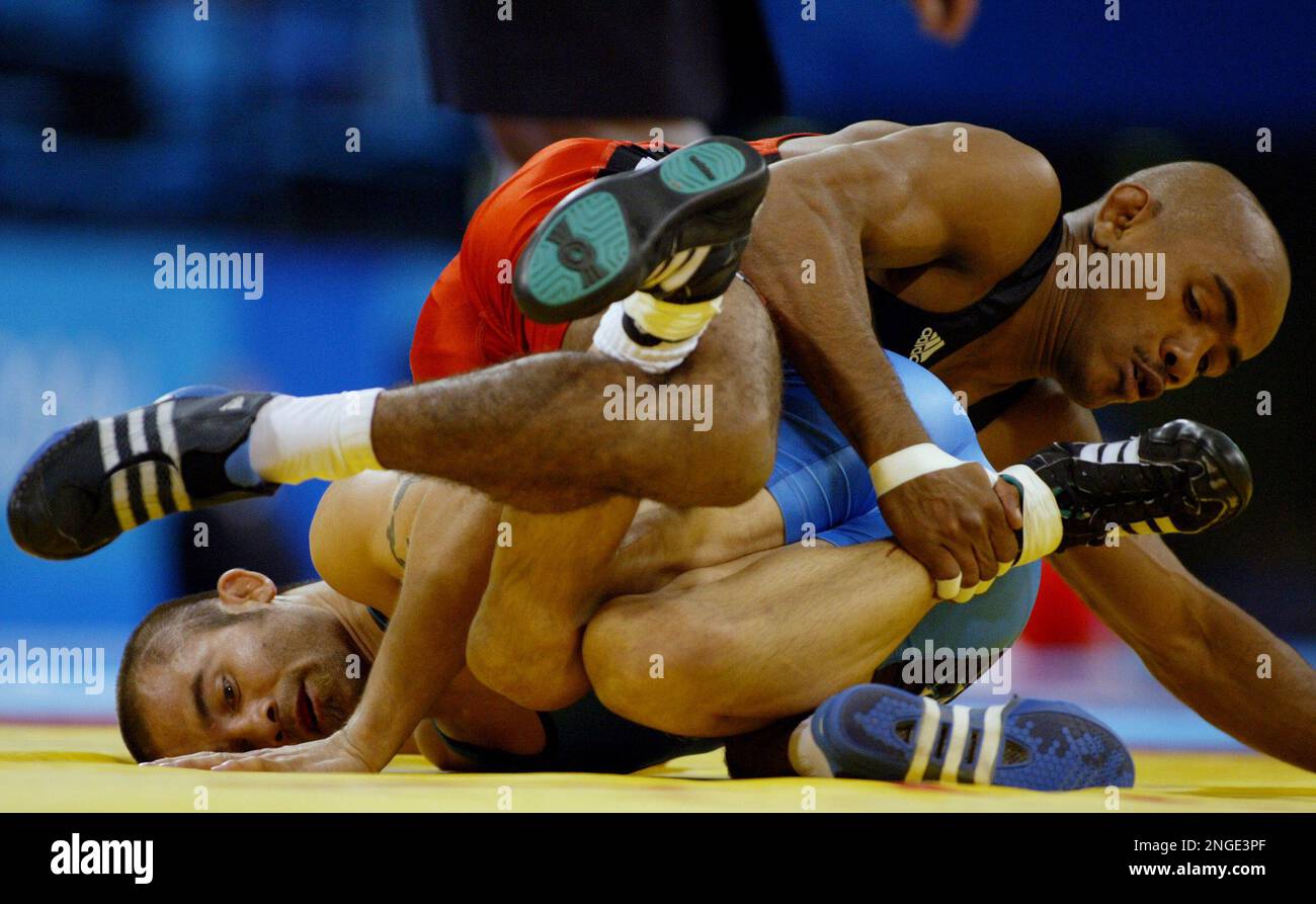 Stephen Abas of the USA, left, and Rene Montero of Cuba wrestle during ...
