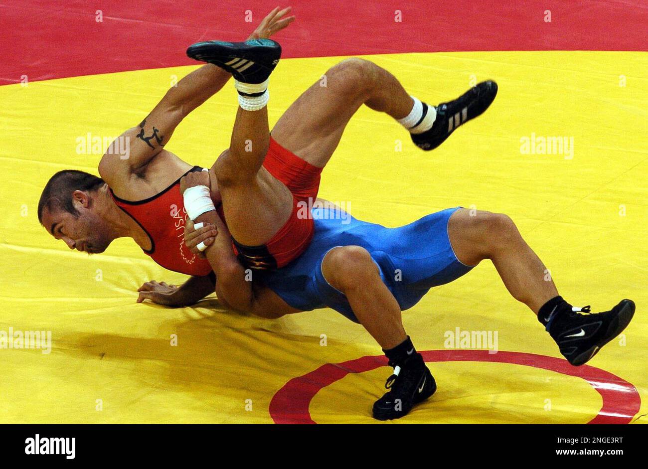 Ly Zhengyu of China, blue, and Stephen Abas, from USA wrestle during a ...
