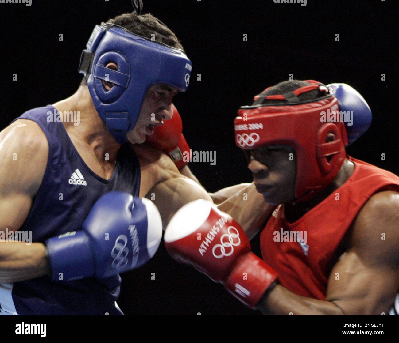 Cuba's Odlanier Solis Fonte, right, and Syria's Naser Al Shami exchange ...