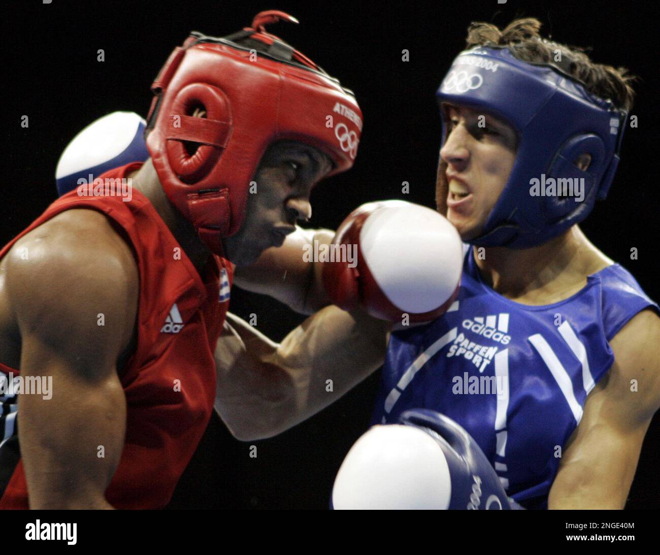 Cuba's Yudel Johnson Cedeno, throws a blow to Bulgaria's Boris Georgiev ...