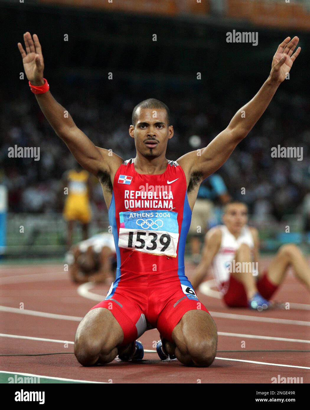 Felix Sanchez, of the Domincan Republic, reacts after winning the gold ...