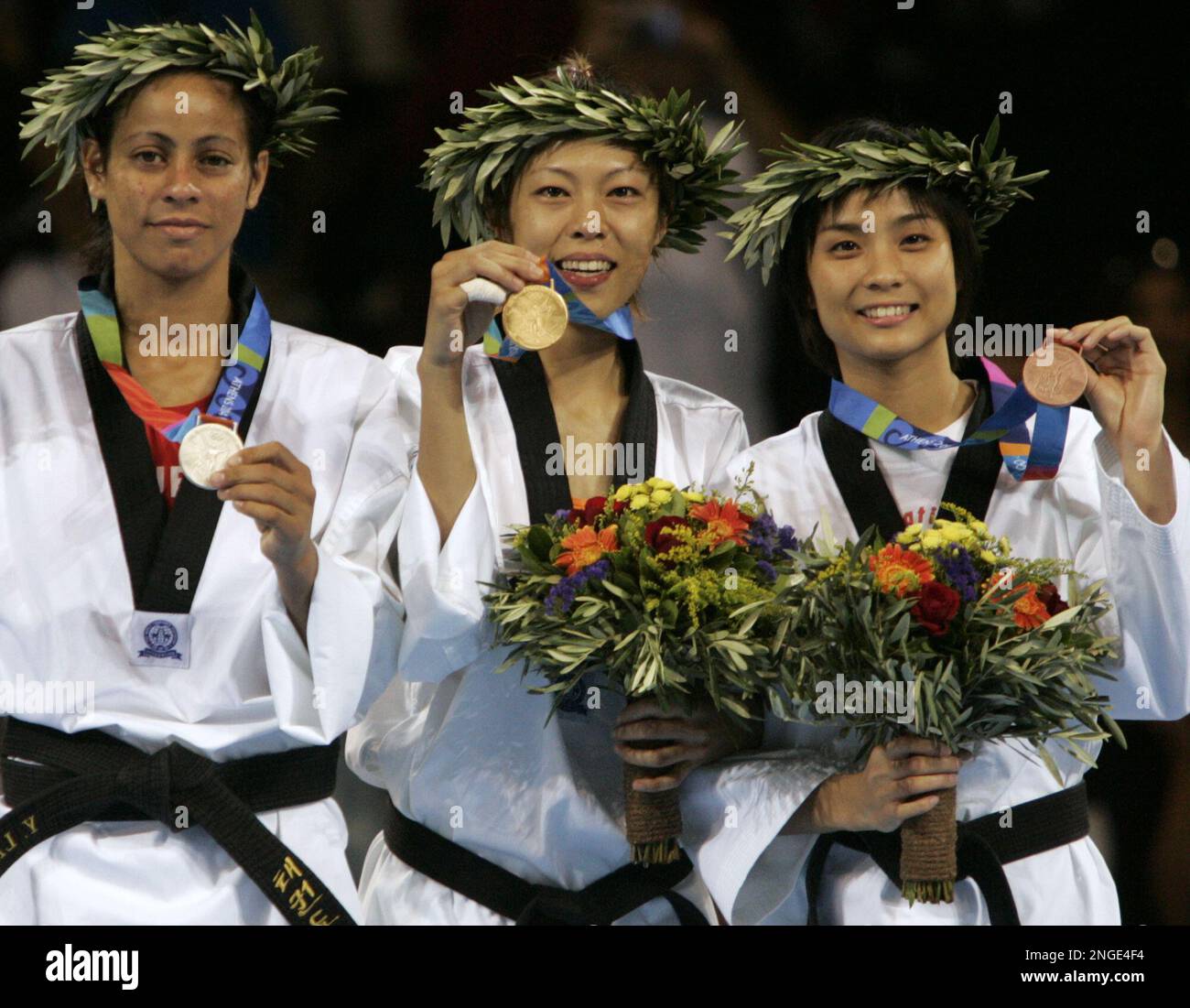 Chen Shih Hsin, center, from Taiwan, displays her gold medal along with ...