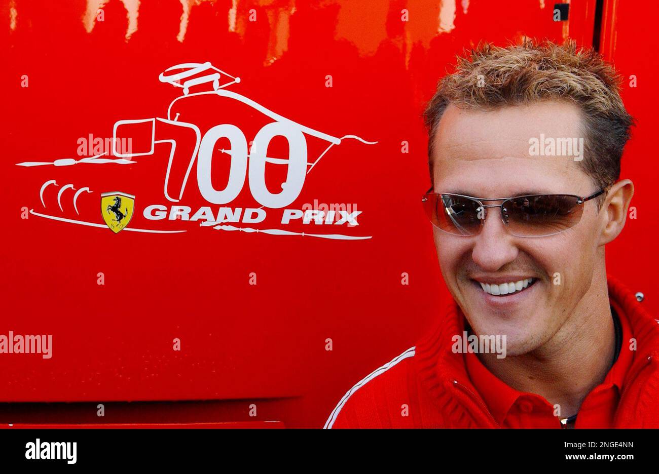 Ferrari driver Michael Schumacher, of Germany, poses next to a truck ...