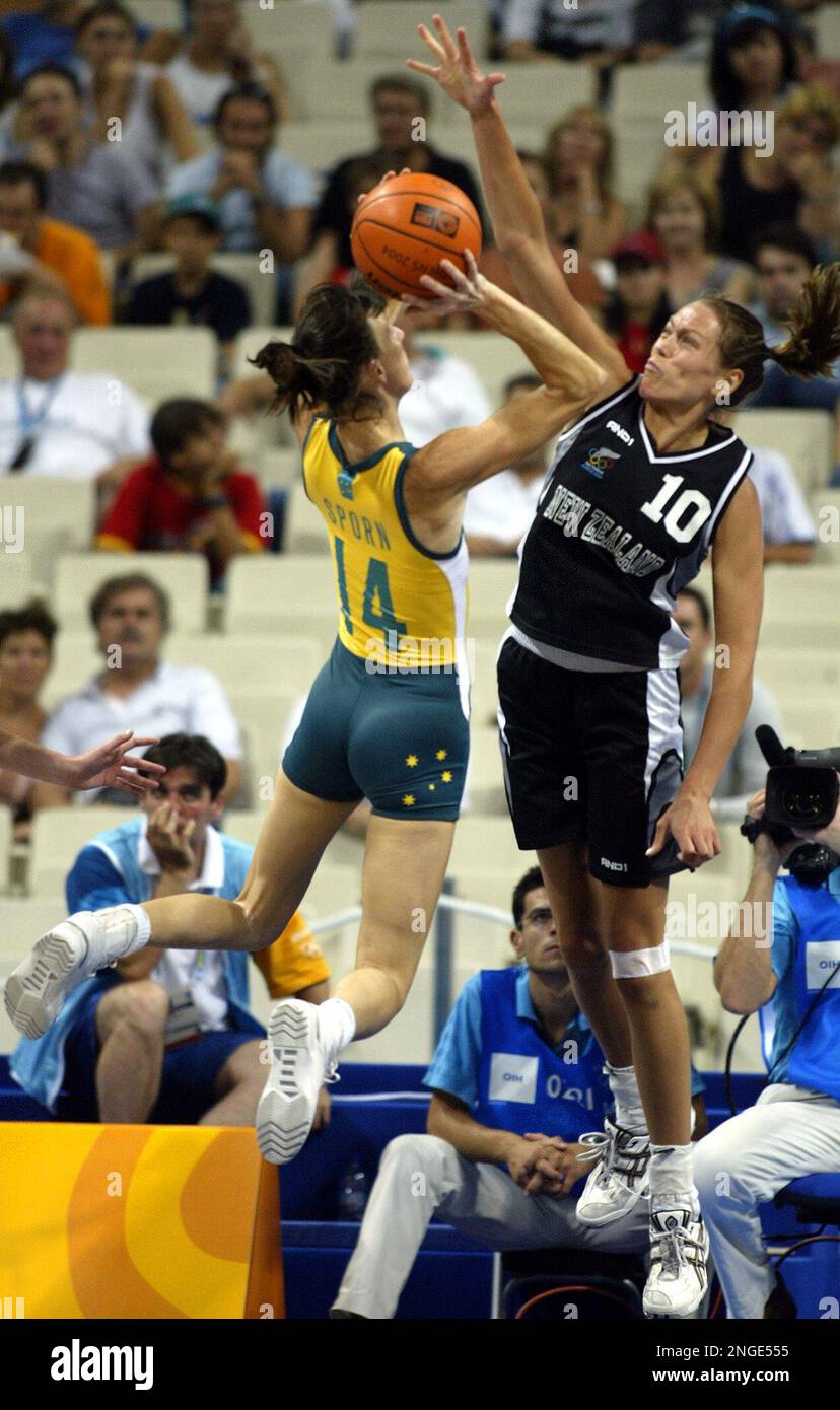 New Zealand's Gina Farmer, left, goes up to block the shot of Australia ...
