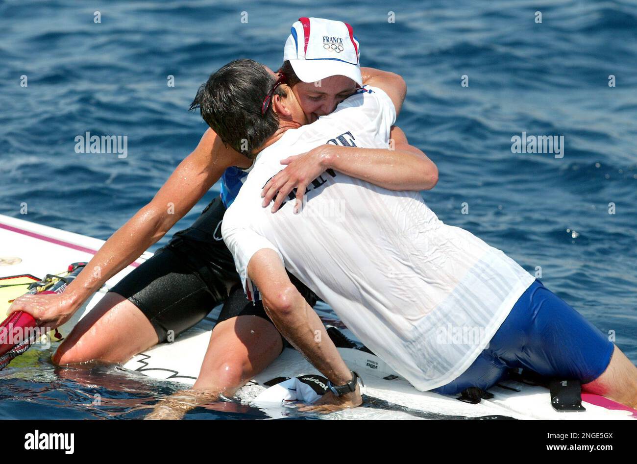 Gold medalist Faustine Merret, left, from France hugs an unidentified ...