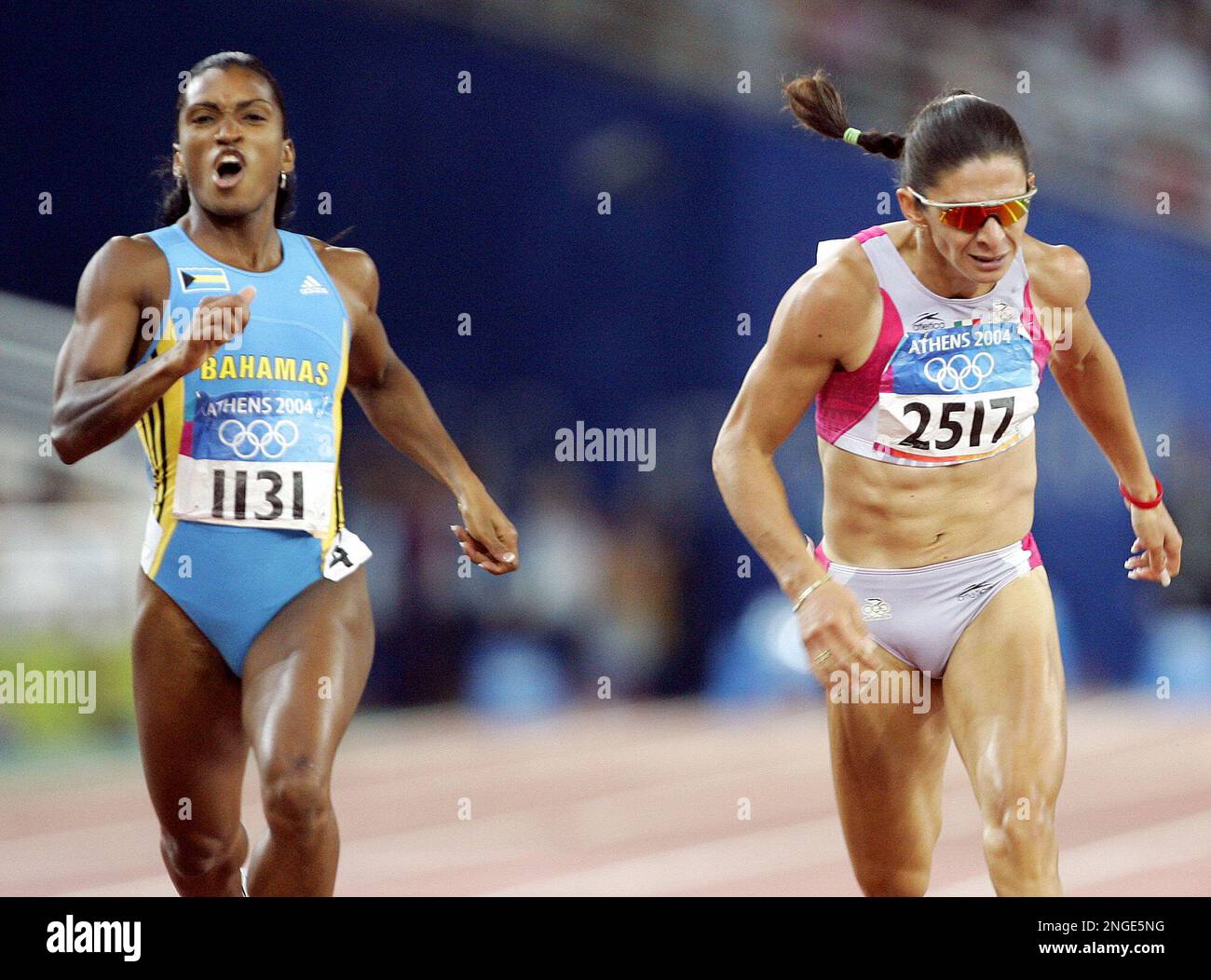 Gold medal winner Tonique Williams-Darling of the Bahamas, left, races ...