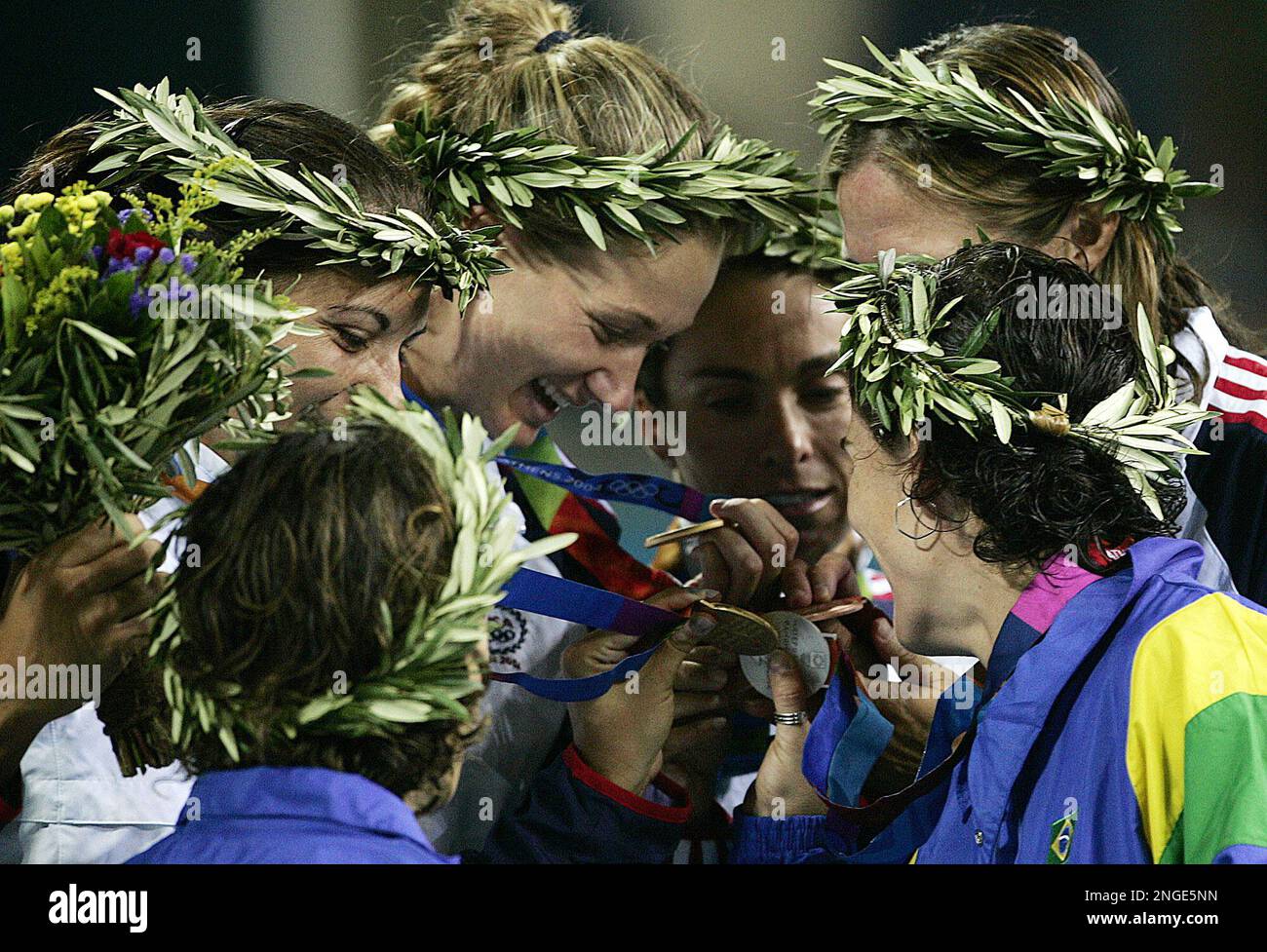 USA's Kerri Walsh, top left, and teammate Misty May, left, show their ...