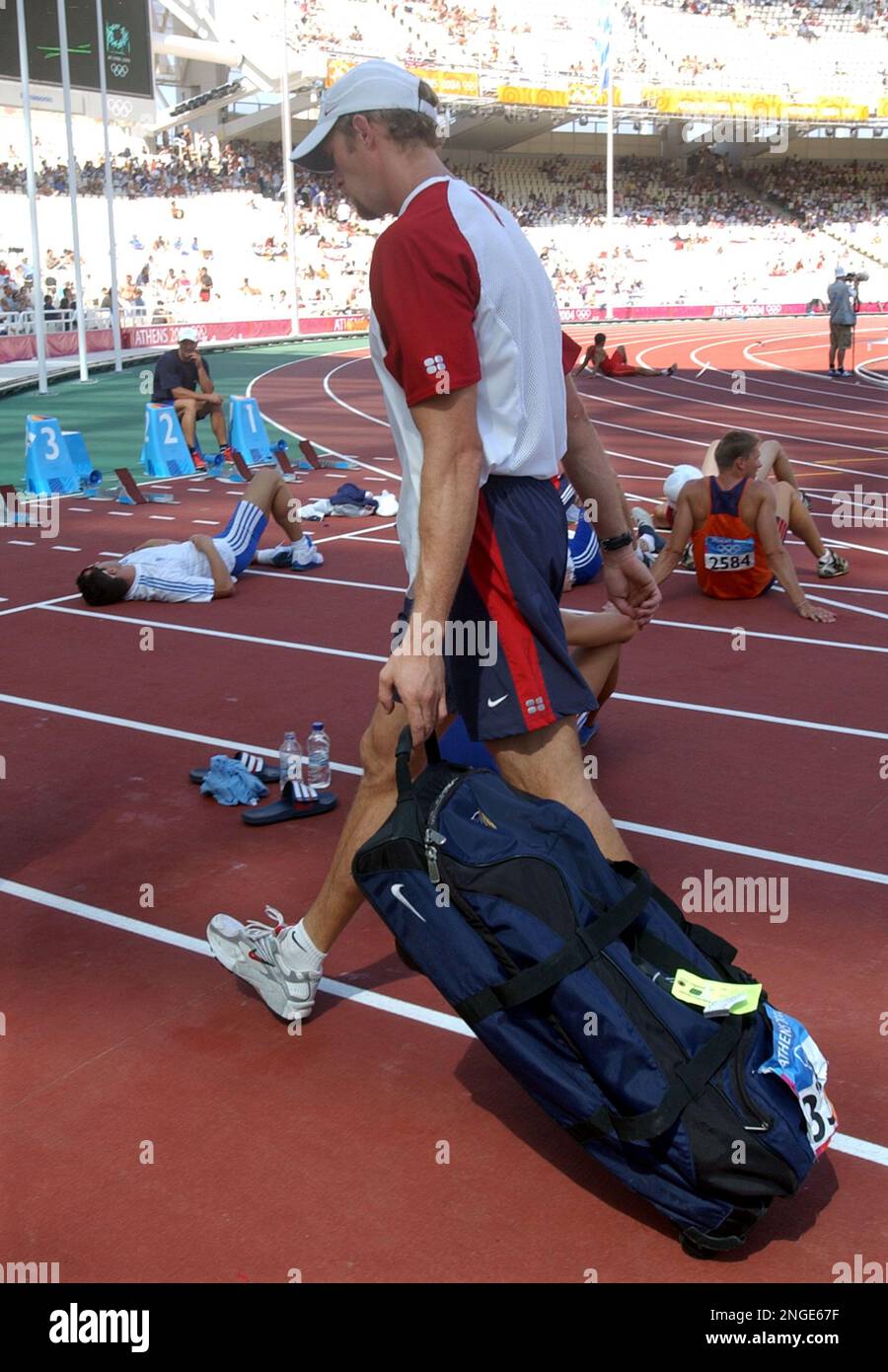 Tom Pappas, of the United States, leaves the track after pulling out of ...