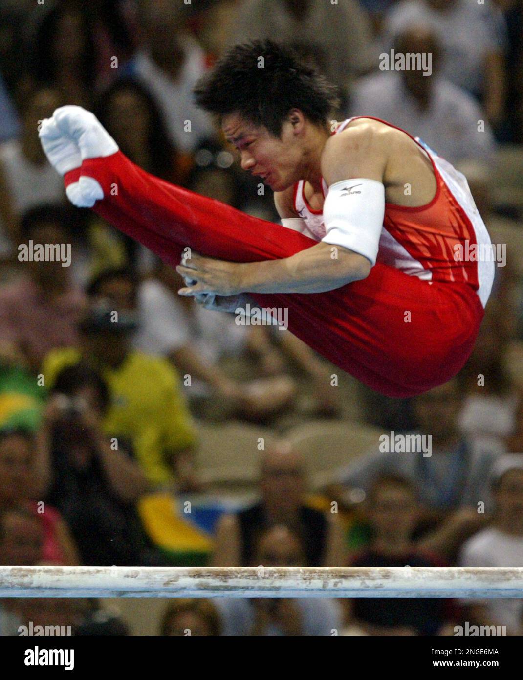 Japan's Hiroyuki Tomita competes on the parallel bars during the men's ...