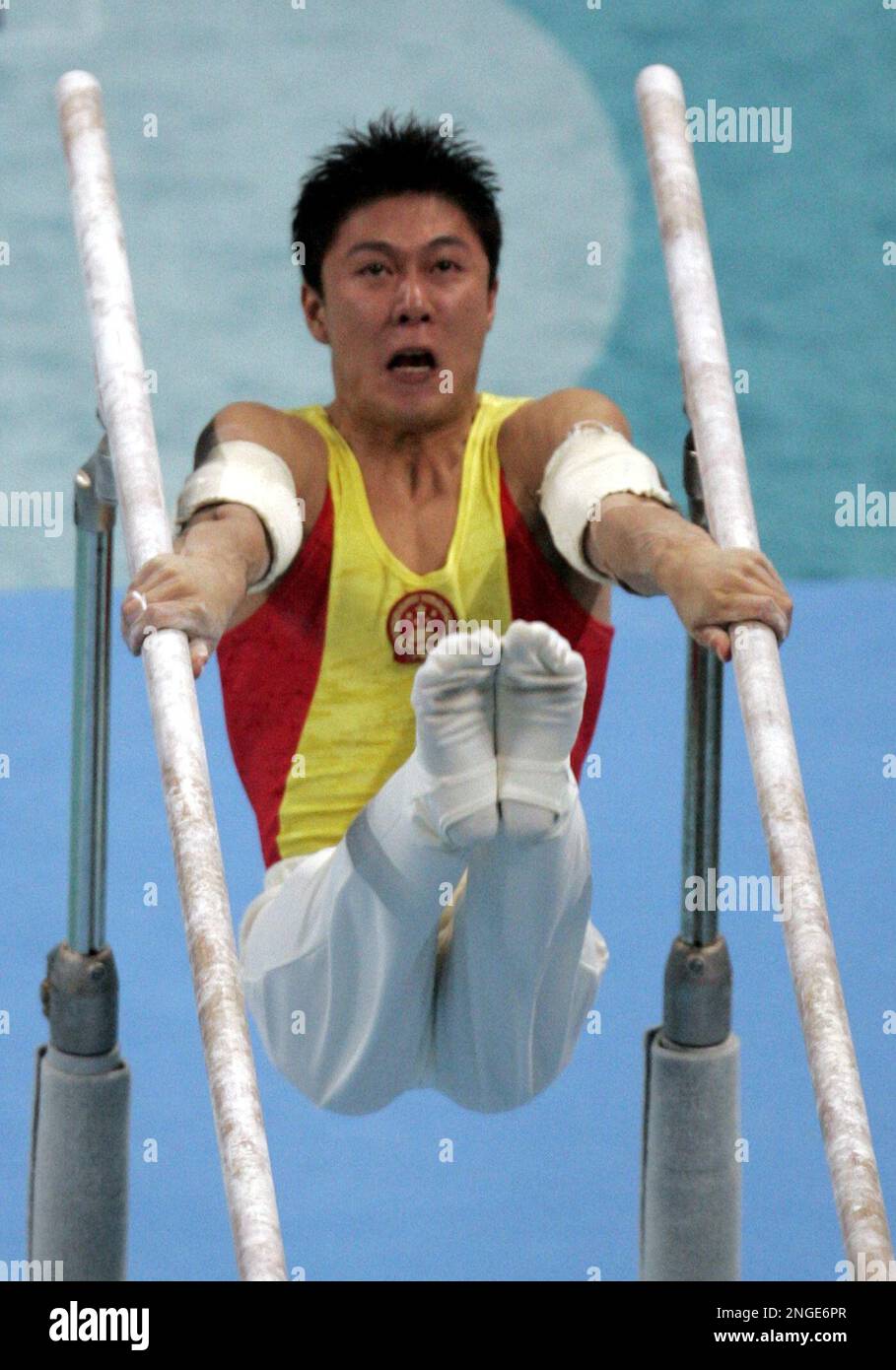 Li Xiaopeng of China competes in the parallel bars during the men's ...