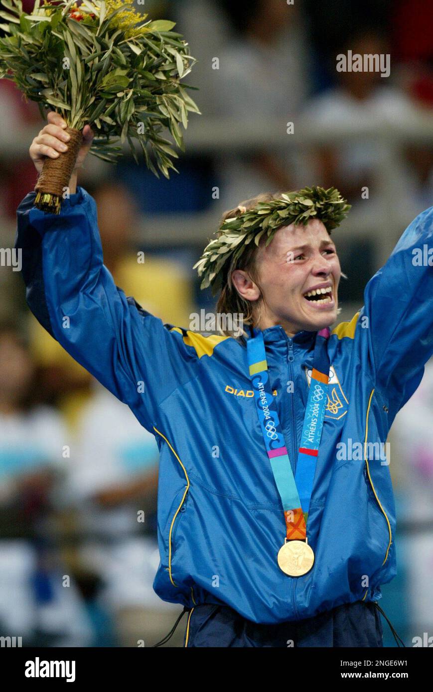 Irini Merleni, from Ukraine, waves after receiving the gold medal for ...